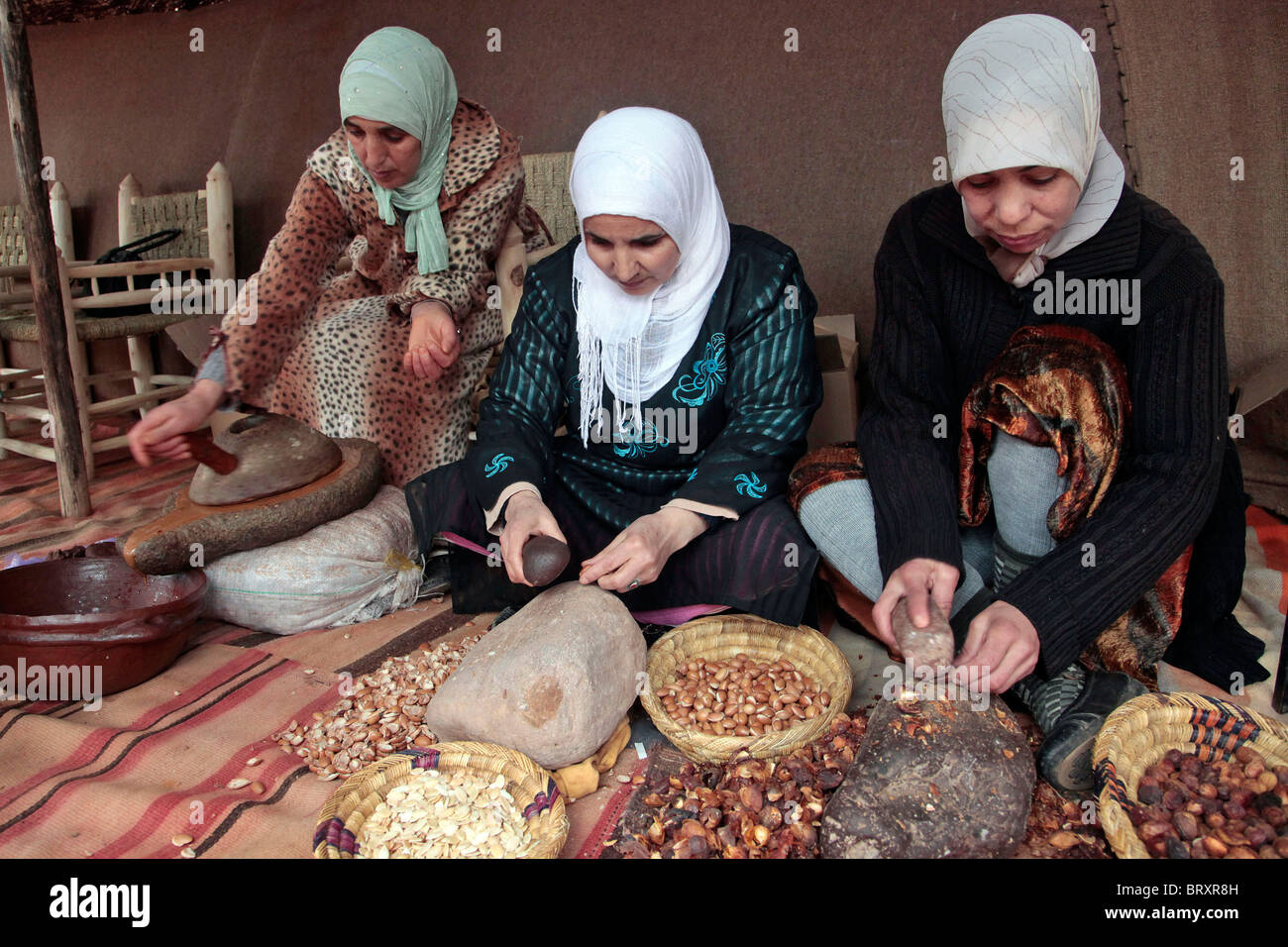 CRAFTSWOMEN CRACKING AND CRUSHING PEANUTS TO EXTRACT THE OIL, TERRES D ...