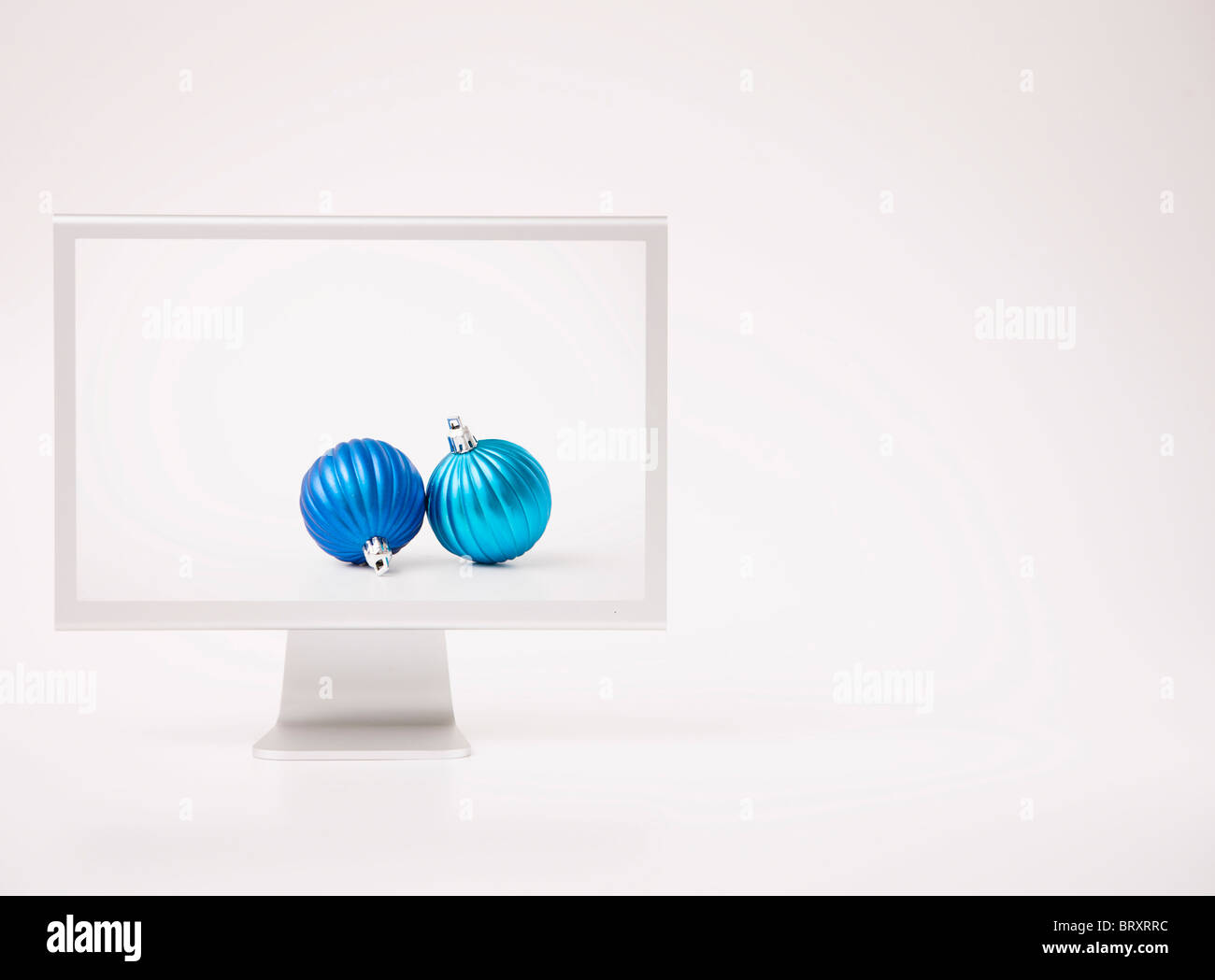 Computer monitor with Christmas baubles Stock Photo - Alamy