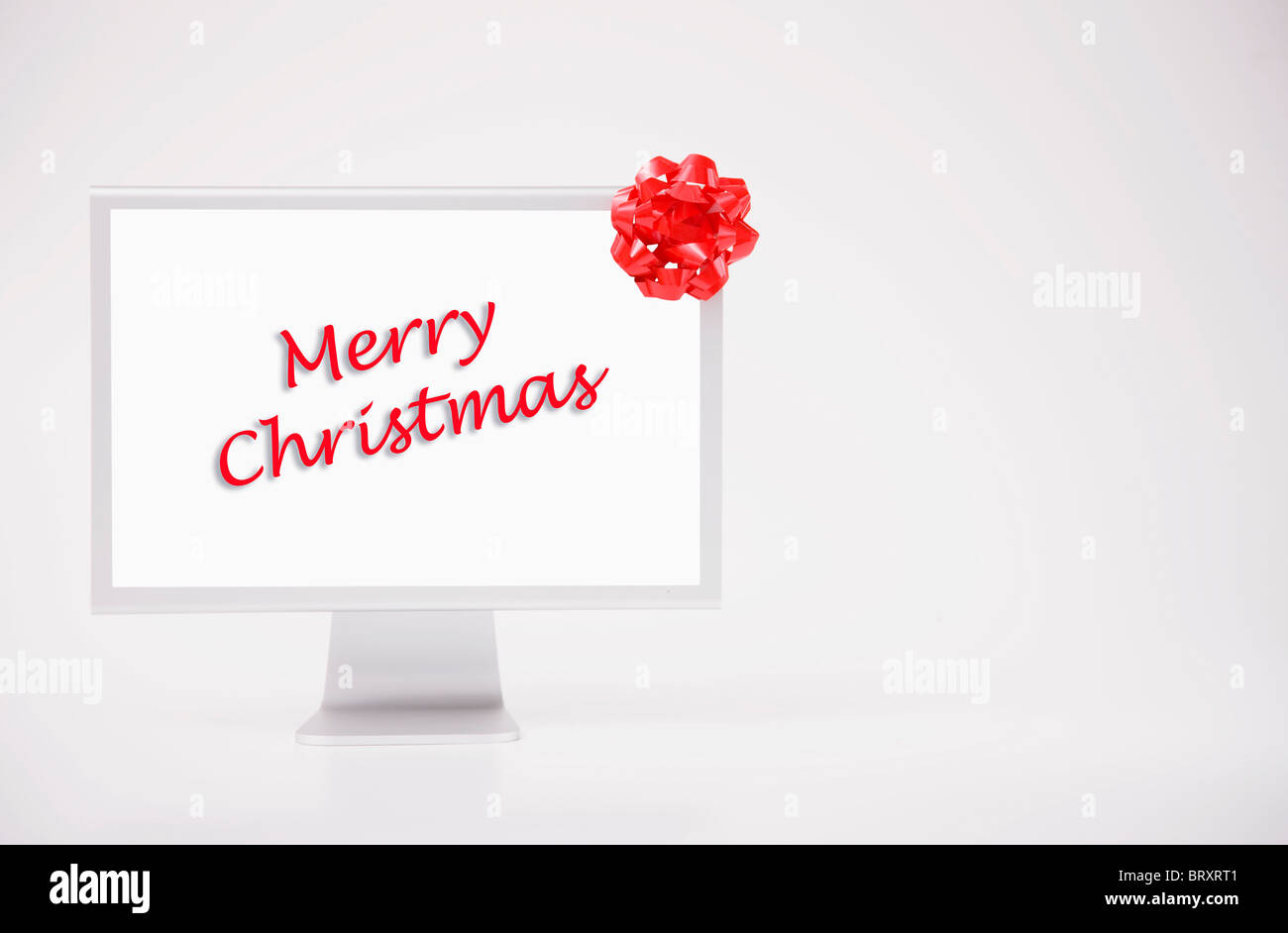 Computer monitor displaying merry Christmas phrase Stock Photo - Alamy