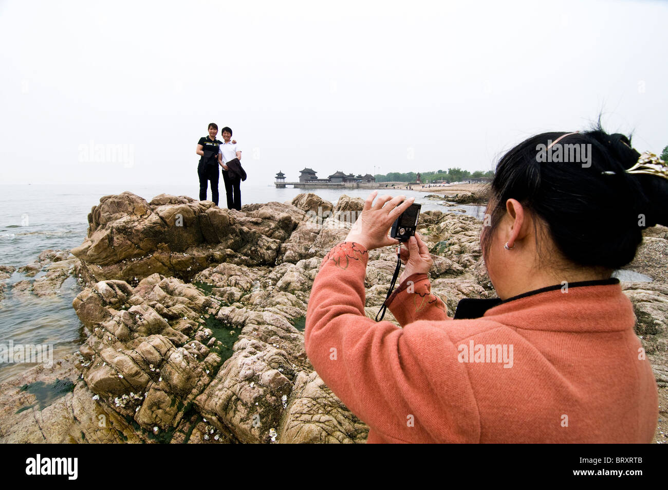 Taking a snap of her friends Stock Photo - Alamy