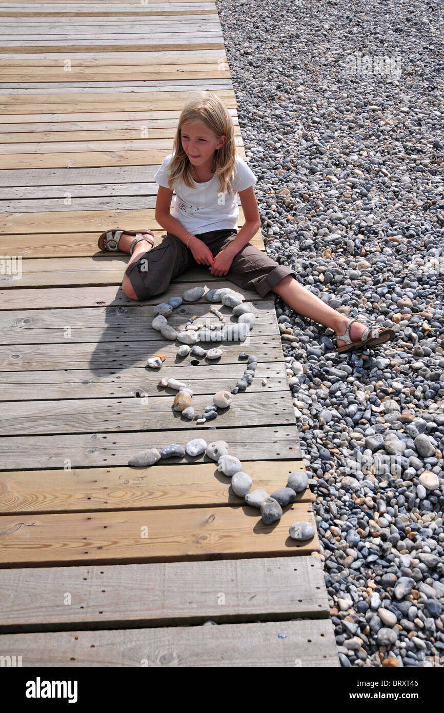 LITTLE GIRL PLAYING WITH PEBBLES, SOMME (80), PICARDY, FRANCE Stock ...