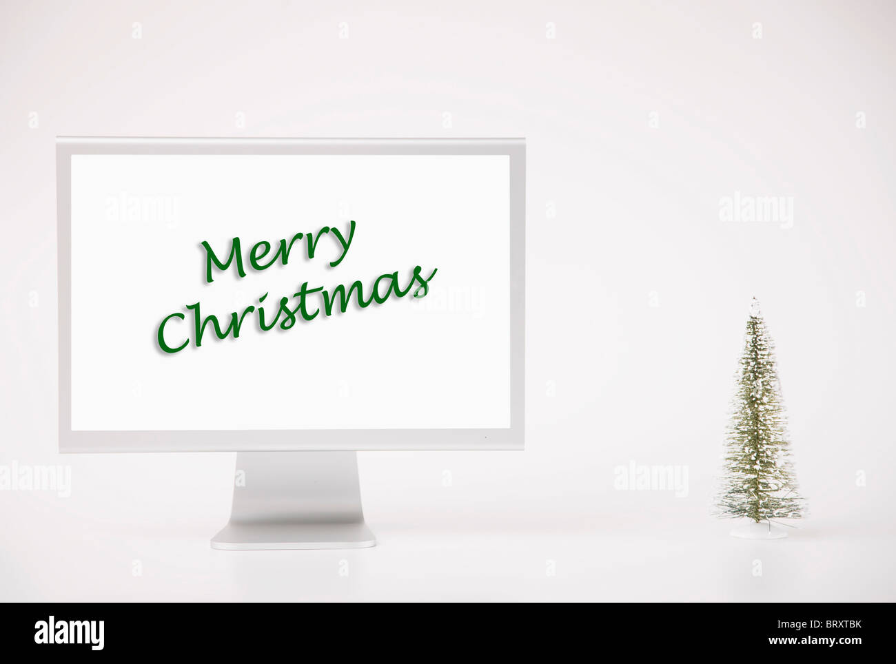 Computer monitor displaying merry Christmas phrase Stock Photo - Alamy