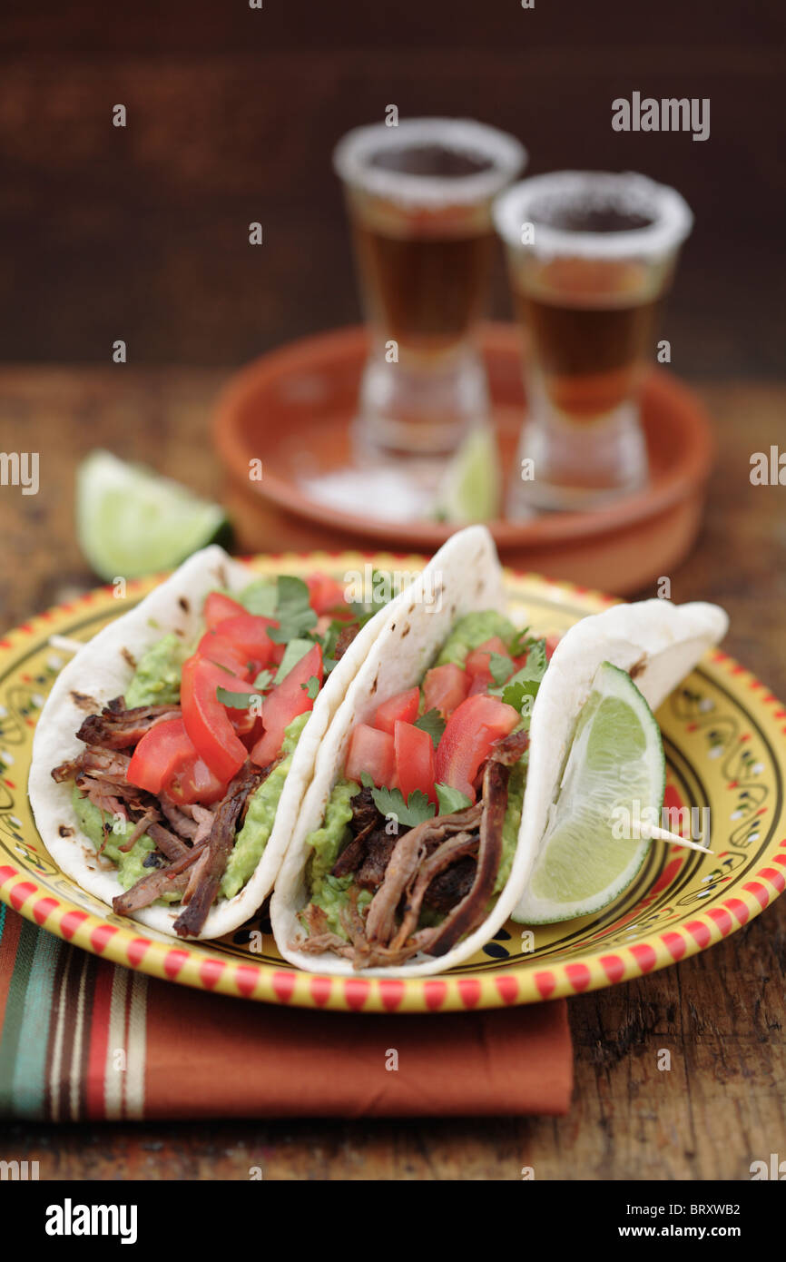 Shredded beef tacos and tequila shots Stock Photo - Alamy