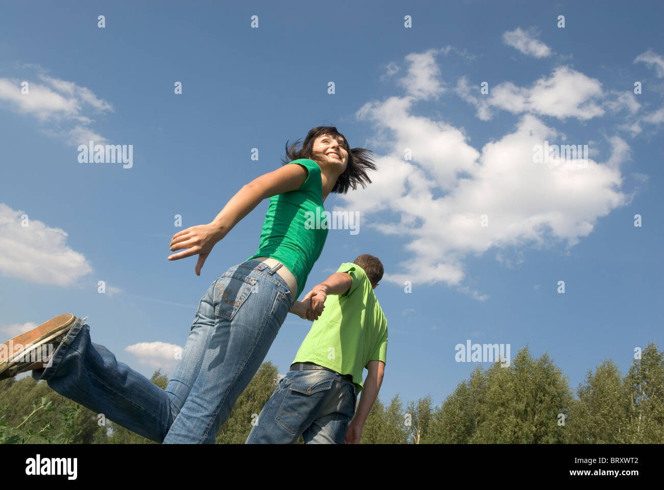 Young couple walking trough field Stock Photo - Alamy
