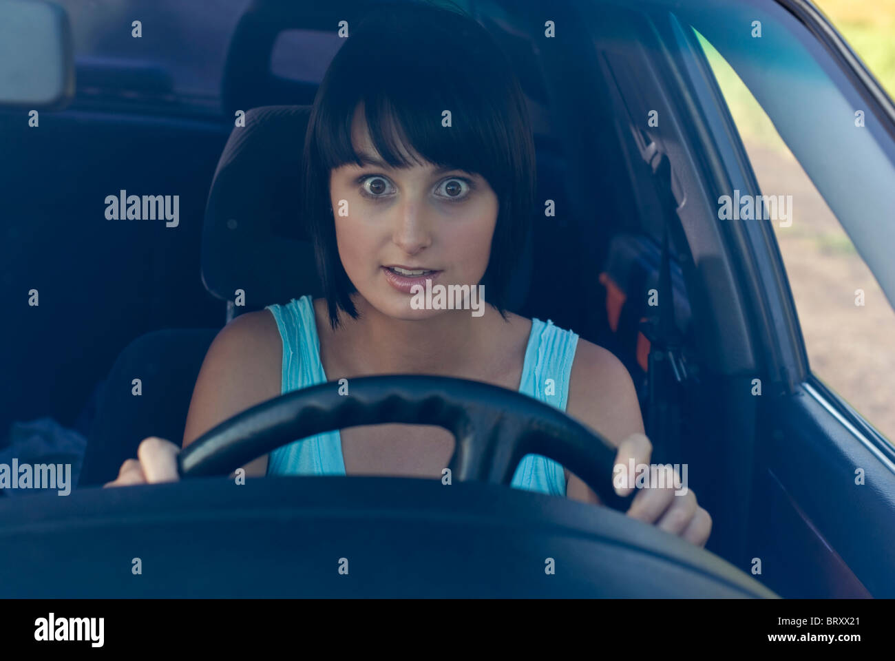 Surprised woman sitting in car Stock Photo - Alamy