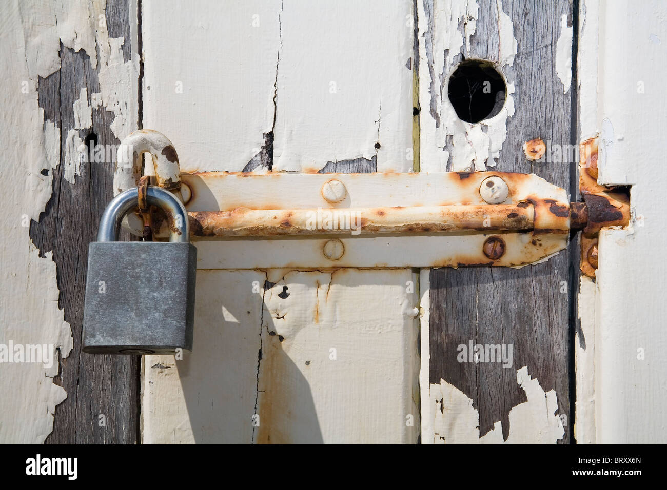 Padlock and rusty bolt on an old wooden door Stock Photo - Alamy