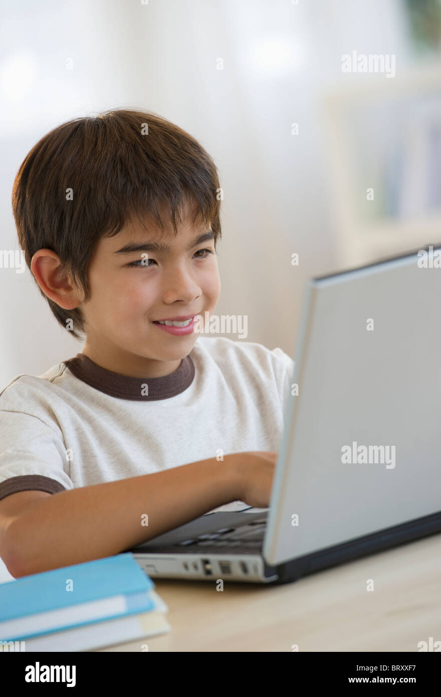 Boy typing on laptop education hi-res stock photography and images - Alamy
