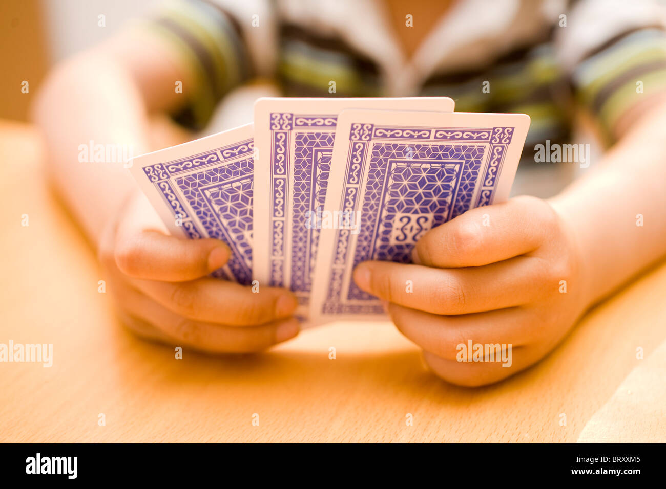 Child holding cards Stock Photo - Alamy