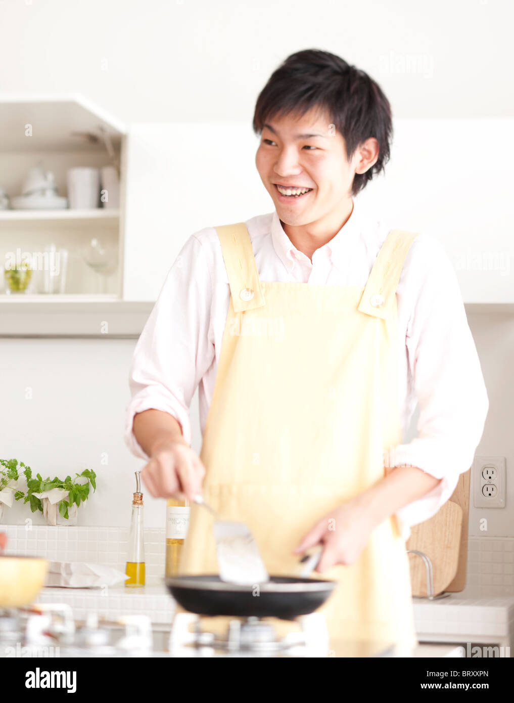 A young man cooking Stock Photo - Alamy