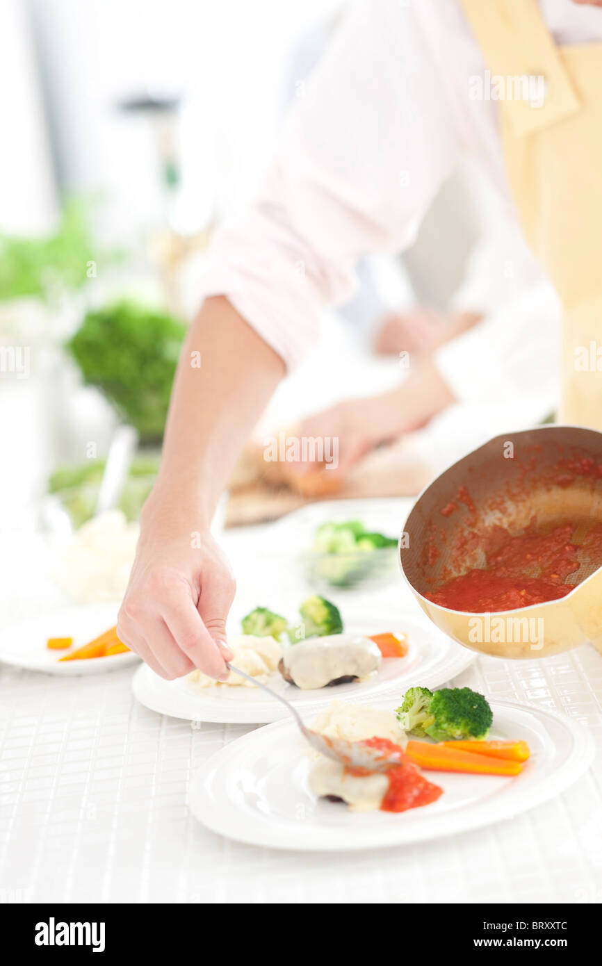 Hands setting meal Stock Photo - Alamy