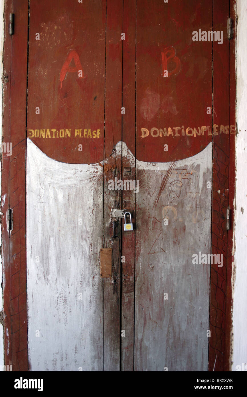 Writing saying donation please forms a sign on doors at a Buddhist ...