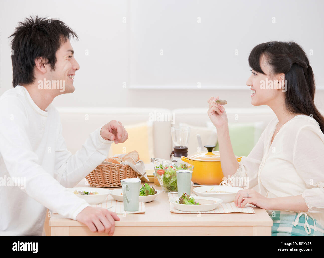 Couple talking at dining table, Japan Stock Photo - Alamy