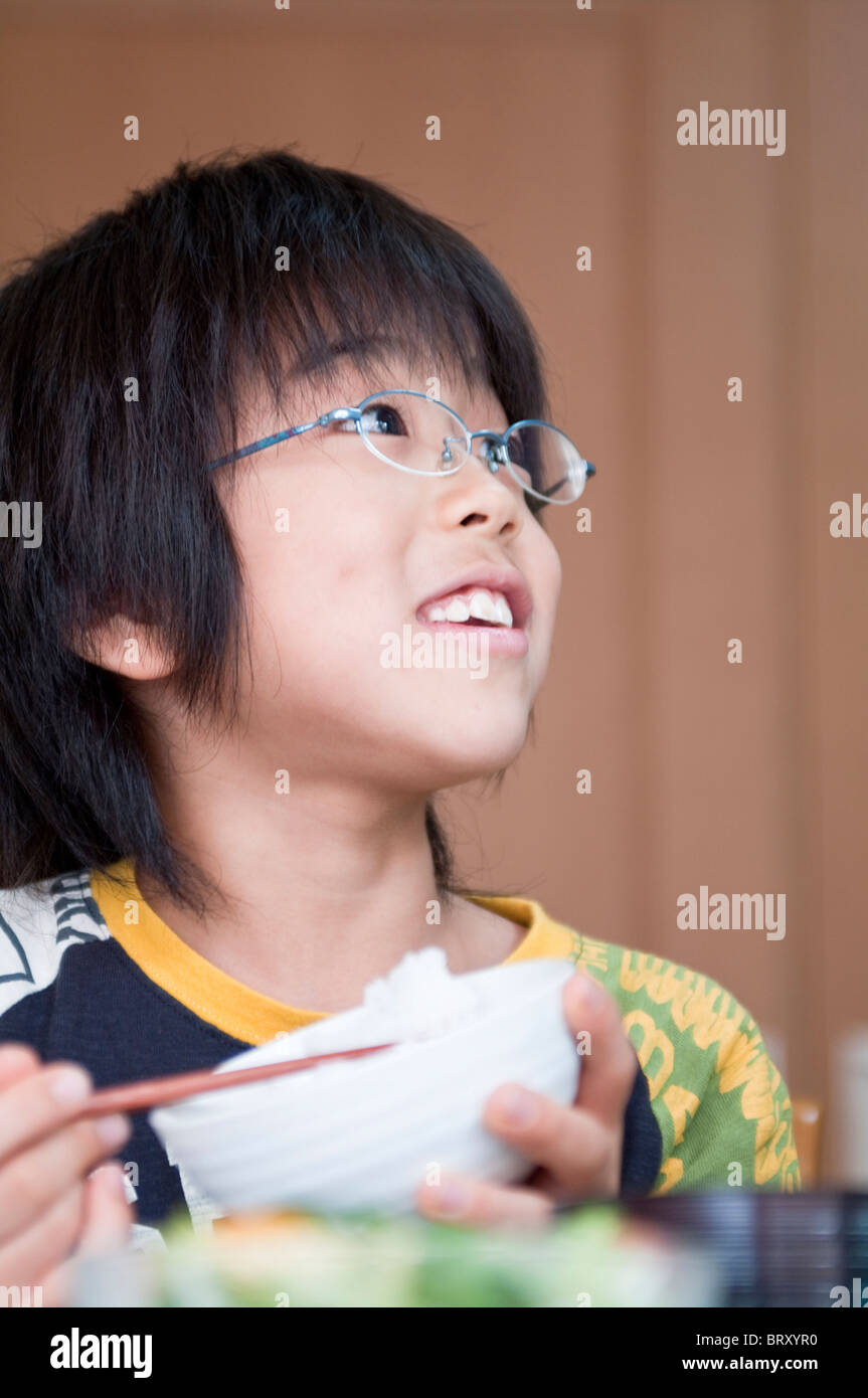 Boy eating rice Japan Stock Photo - Alamy