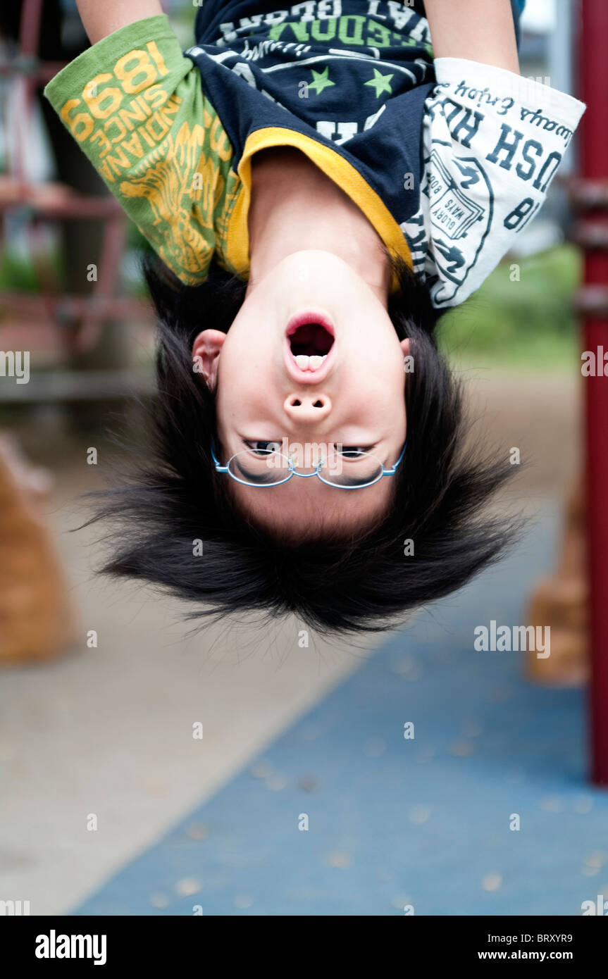 Boy hanging upside down from hi-res stock photography and images - Alamy