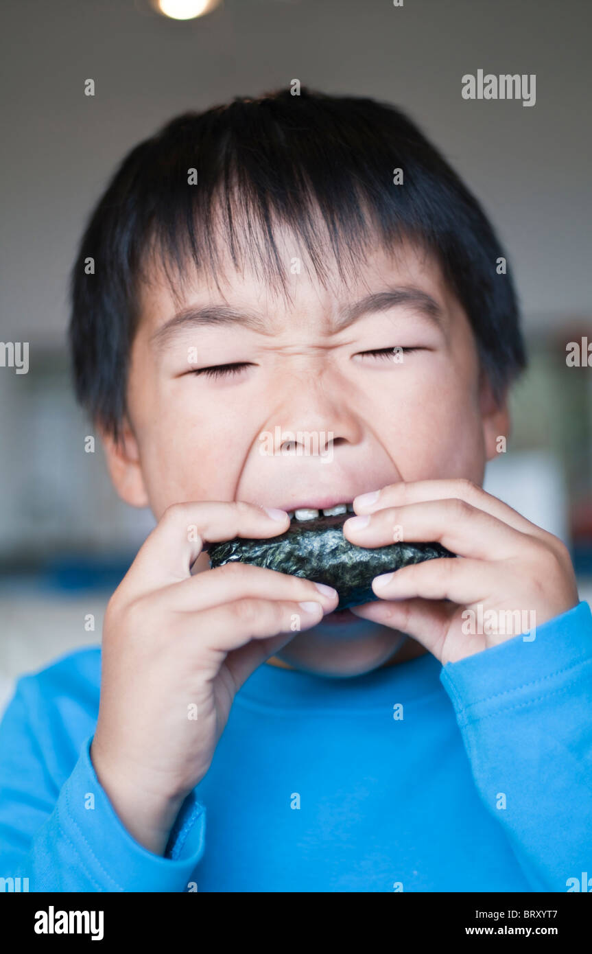 Boy eating rice ball Japan Stock Photo - Alamy