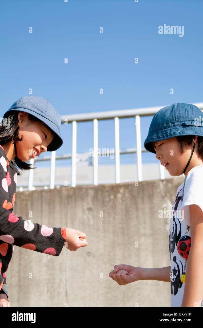 Two boys rock paper scissors hi-res stock photography and images - Alamy