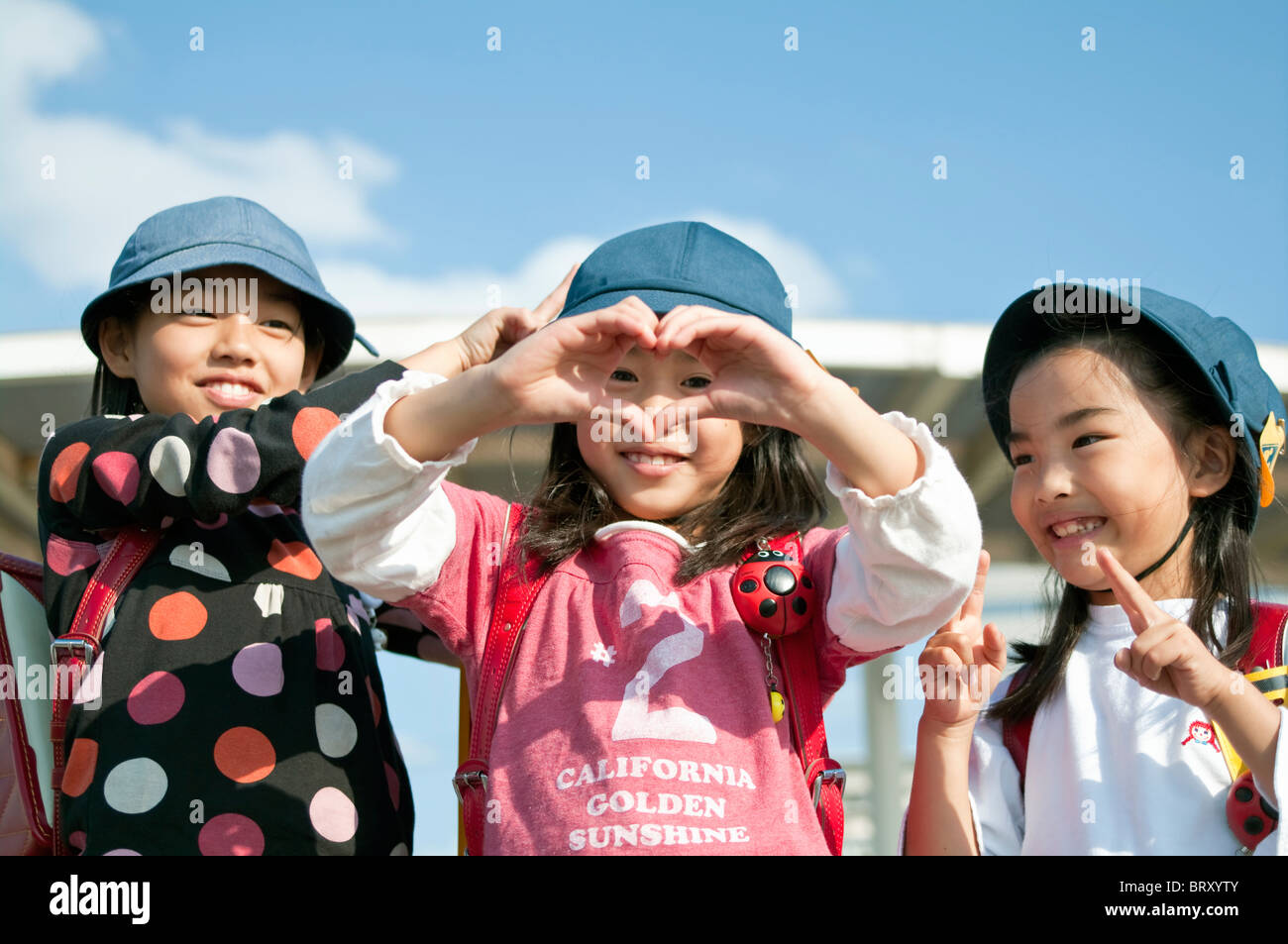 Girl making heart shape with hands Japan Stock Photo - Alamy