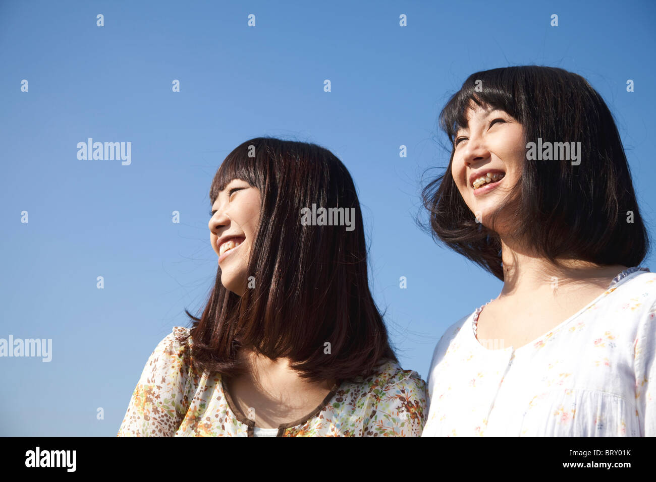 Two Young Women Smiling Stock Photo - Alamy