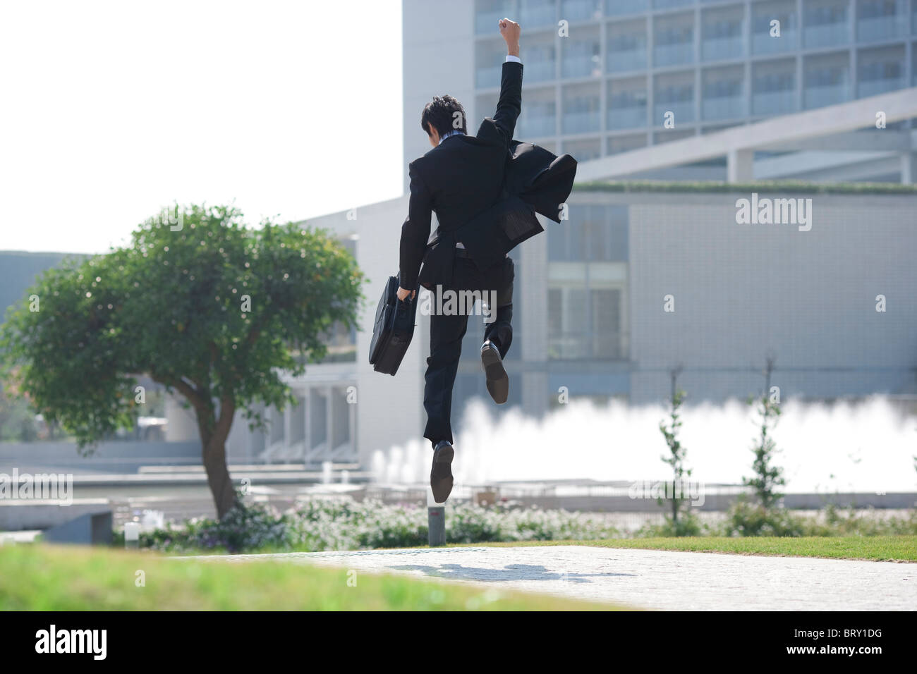 A businessman jumping Stock Photo - Alamy