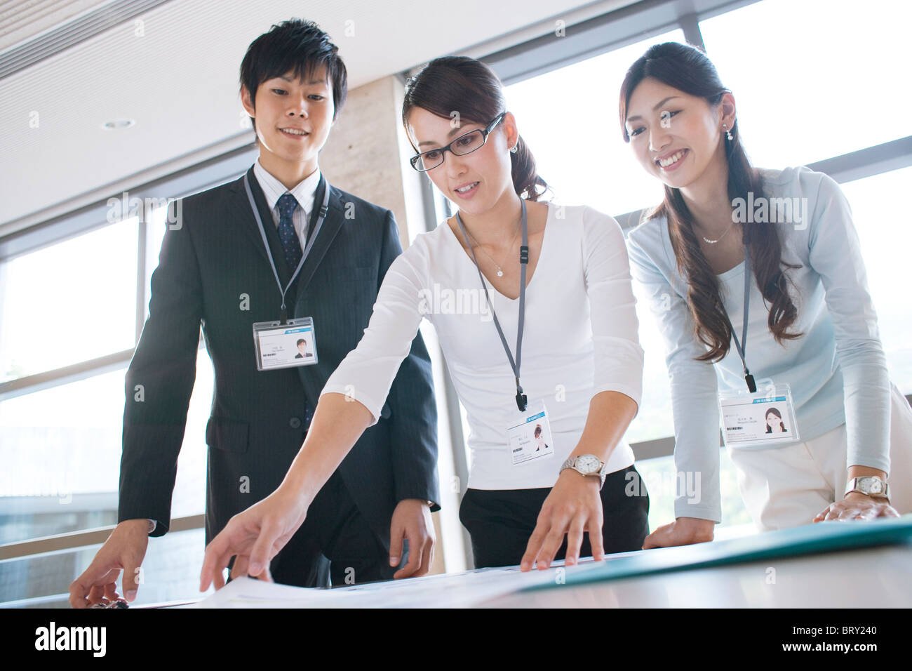 Business people looking at documents Stock Photo - Alamy