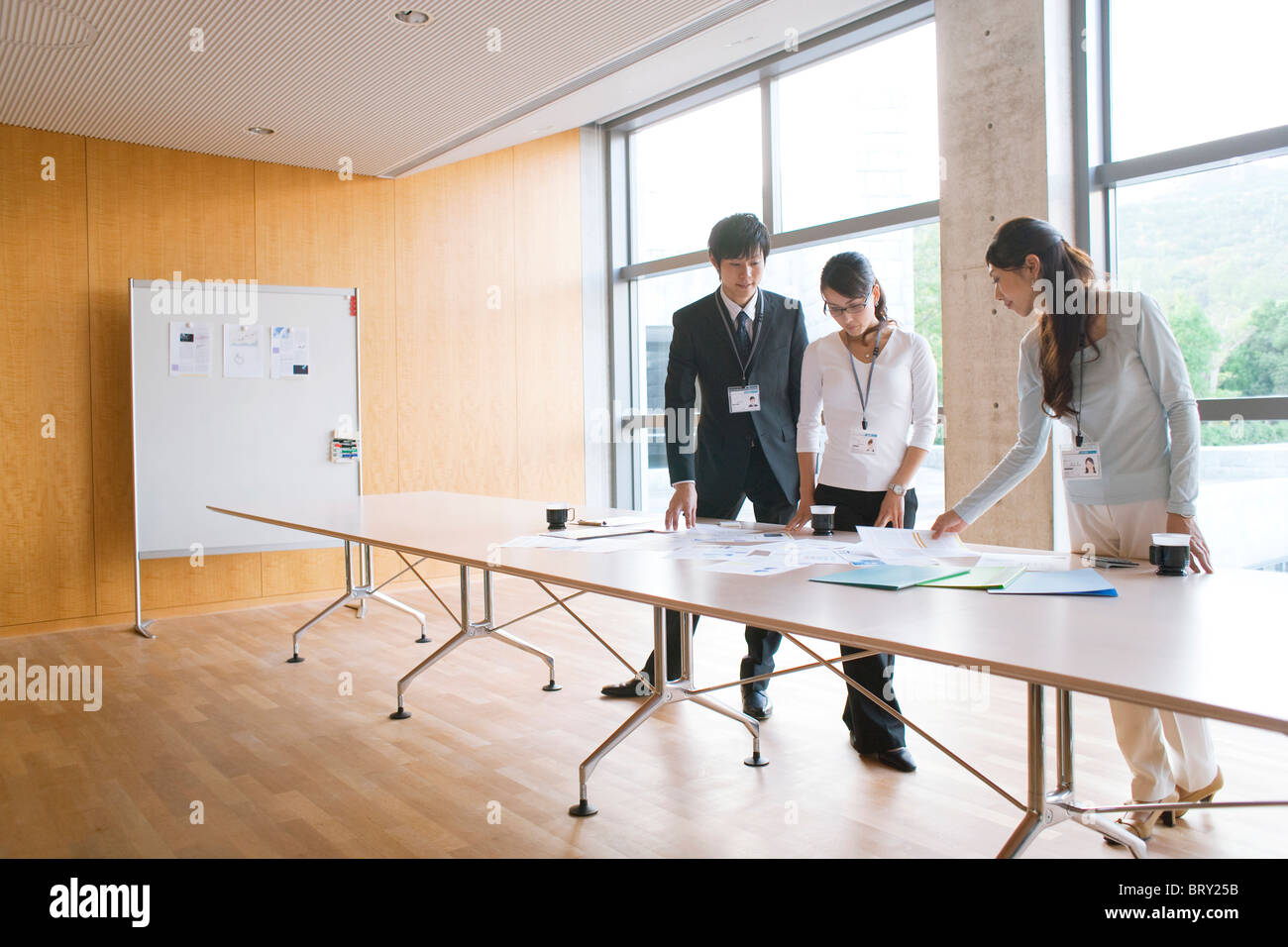 Business people looking at documents Stock Photo - Alamy