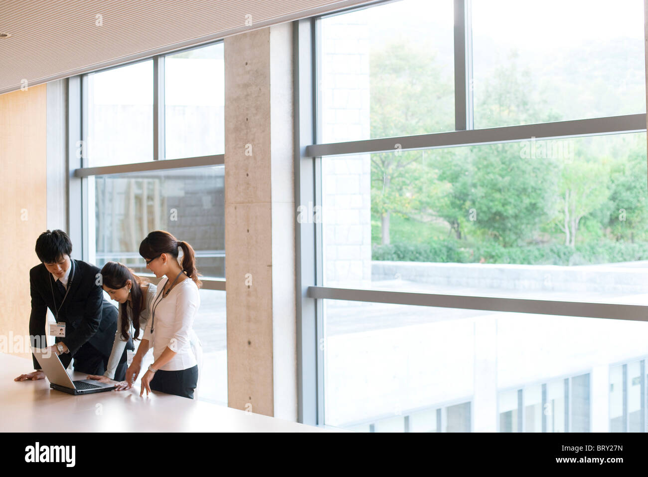 Business people looking at computer Stock Photo - Alamy