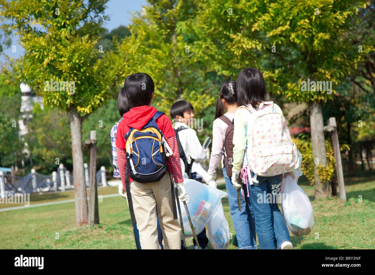 School children carrying bags for recycling Stock Photo - Alamy
