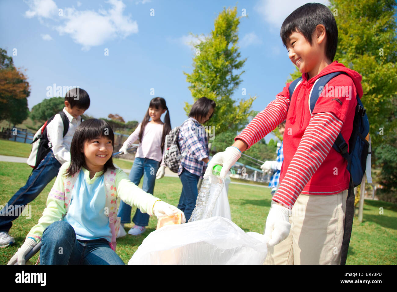 School children picking garbage in park hi-res stock photography and ...