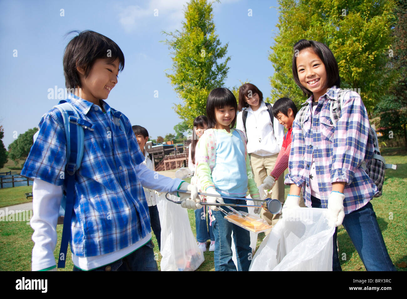 School children picking garbage in park Stock Photo - Alamy