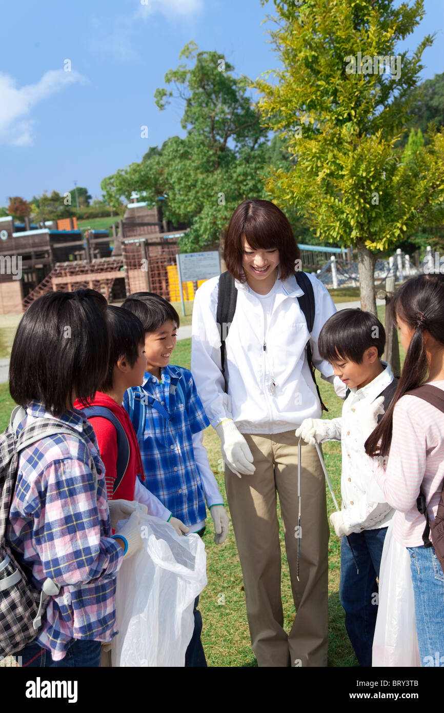 School children and female teacher holding bags for recycling Stock ...
