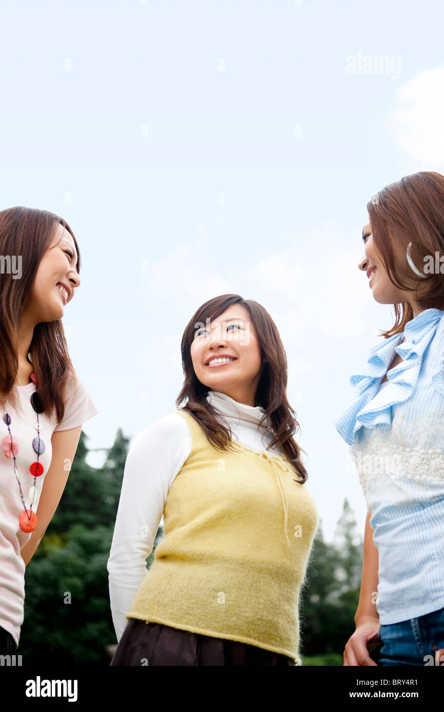 Three young women smiling, copy space Stock Photo - Alamy
