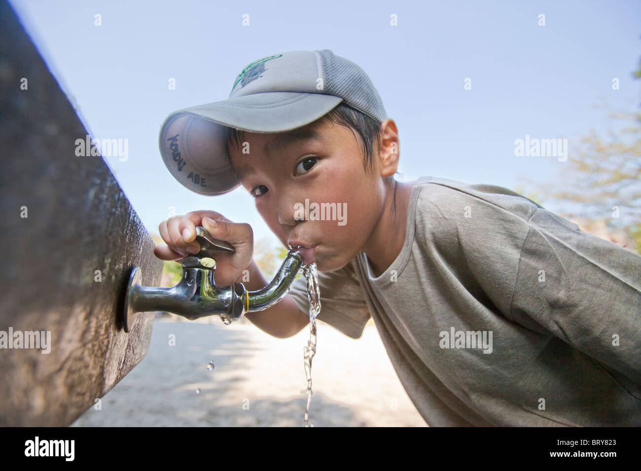 Boy drinking water from faucet, Japan Stock Photo - Alamy