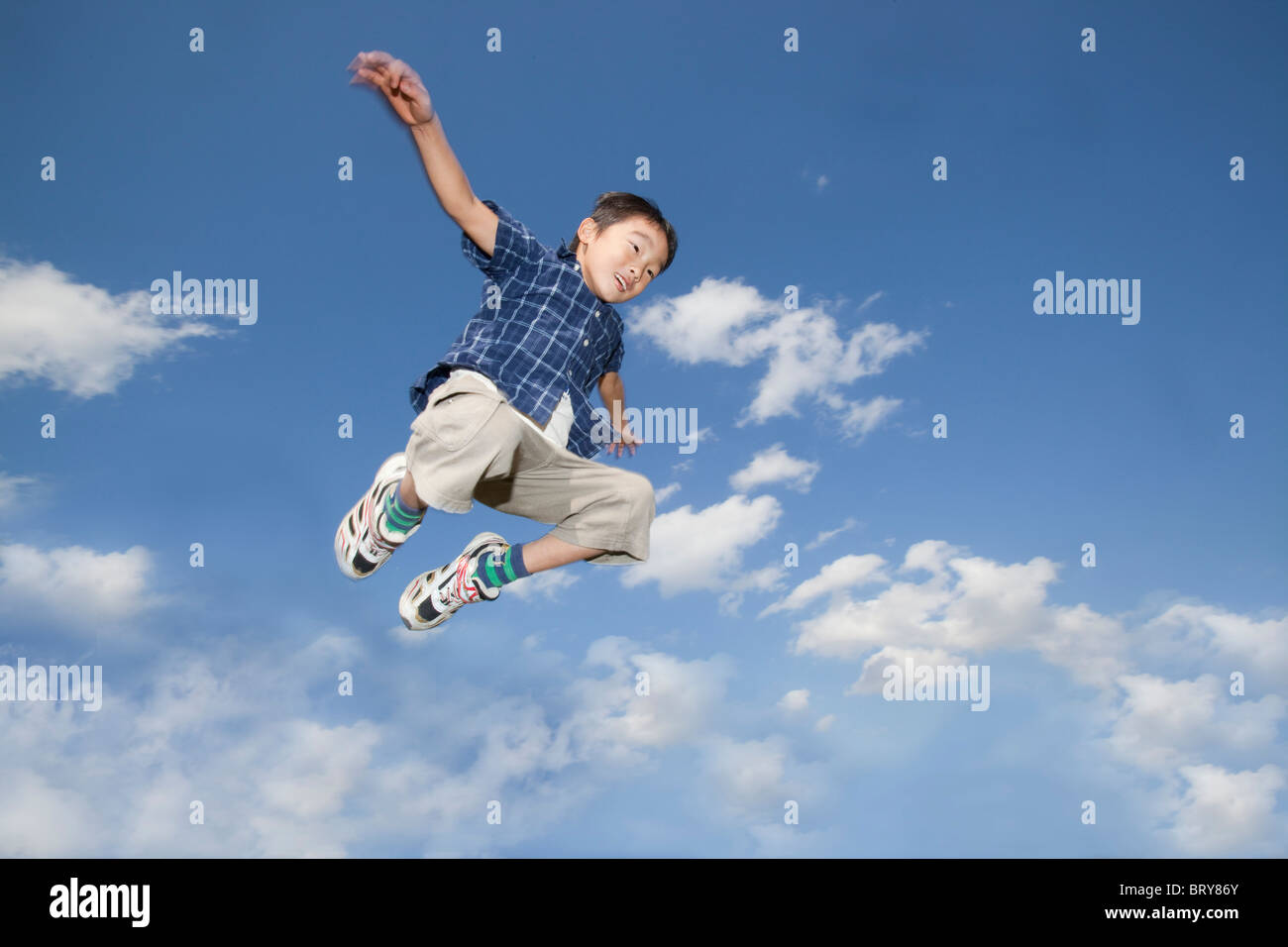 Boy jumping in air, Japan Stock Photo - Alamy