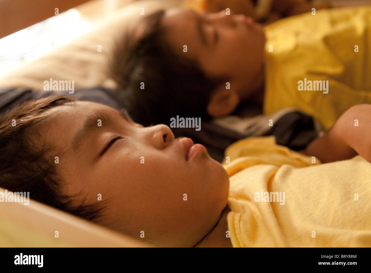 Boys sleeping in bed, Japan Stock Photo - Alamy