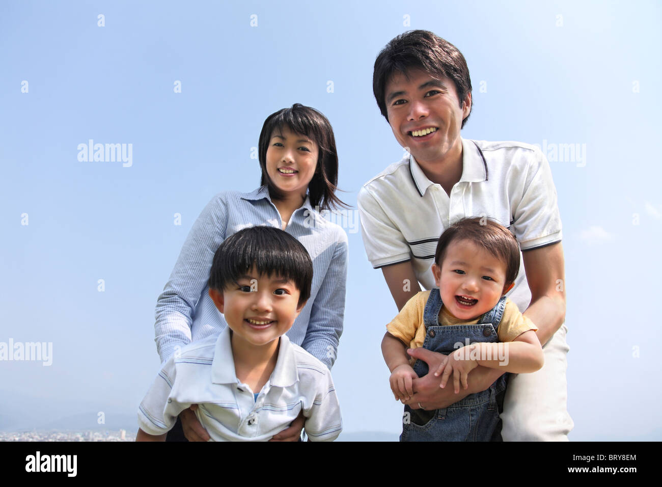 Family with Two Children Smiling at Camera Stock Photo - Alamy