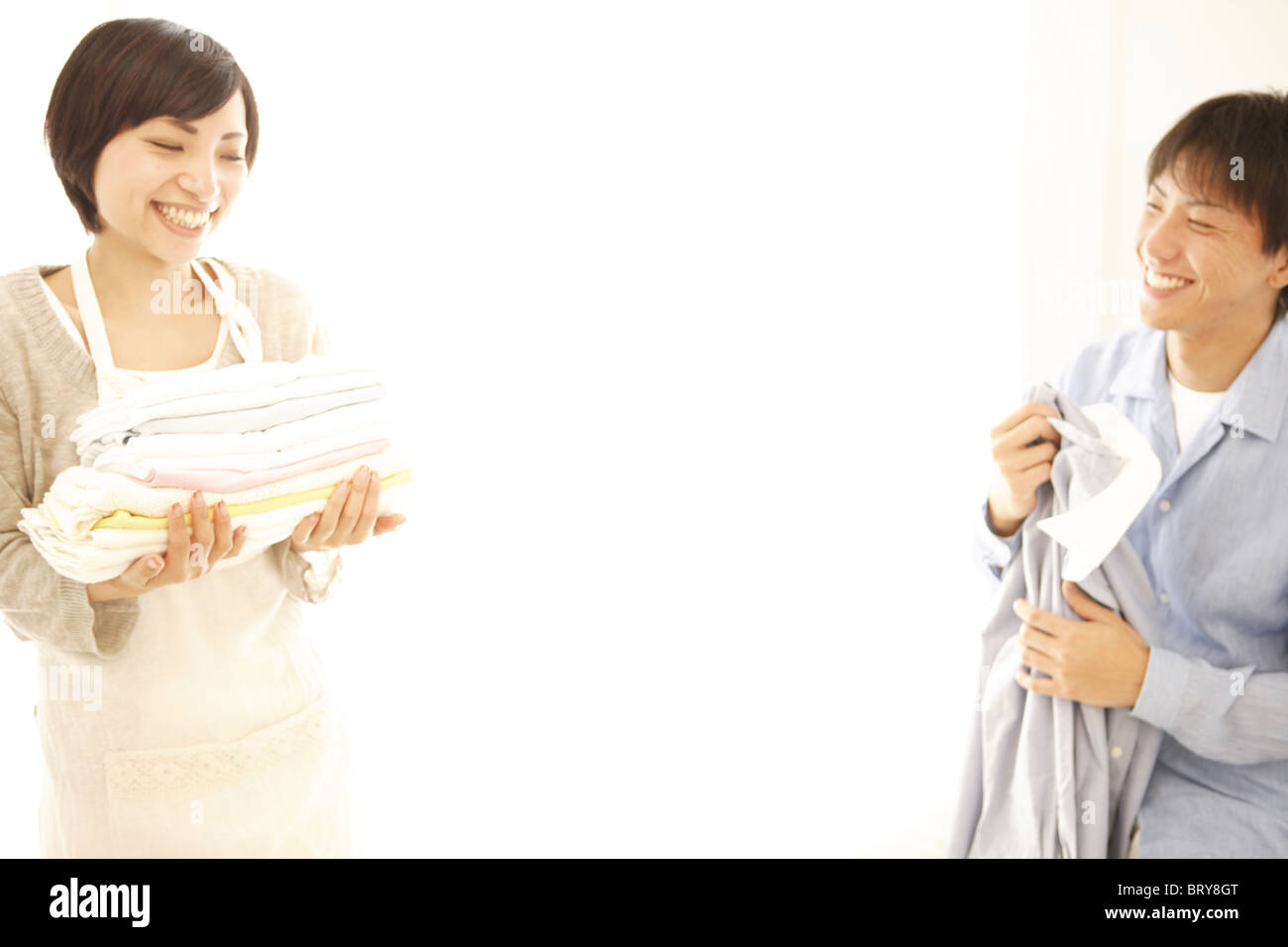 Young Couple Putting the Laundry Away Stock Photo - Alamy