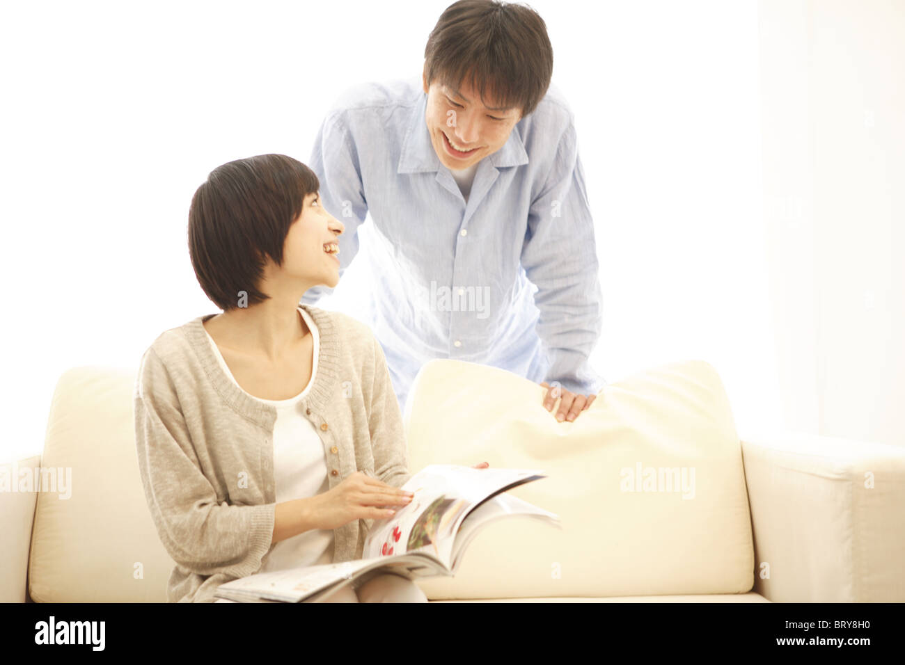 Young Couple Talking at Sofa Stock Photo - Alamy