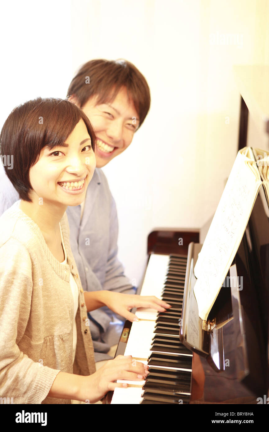 Young Couple Playing the Piano Together Stock Photo - Alamy
