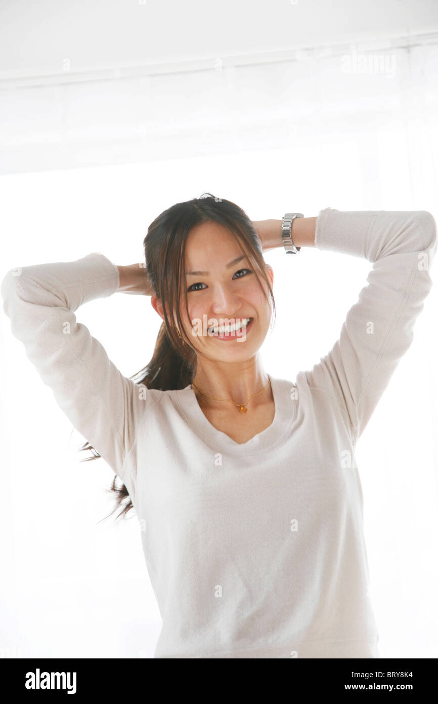 Young Woman Pushing Her Hair Back Stock Photo - Alamy