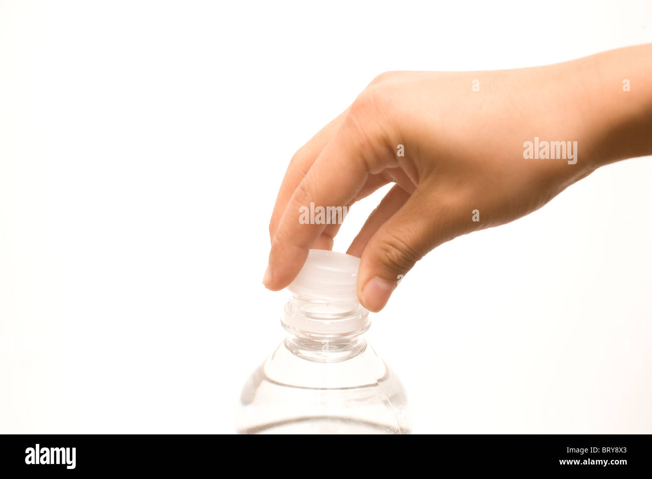 Child's hand closing water bottle cap Stock Photo - Alamy