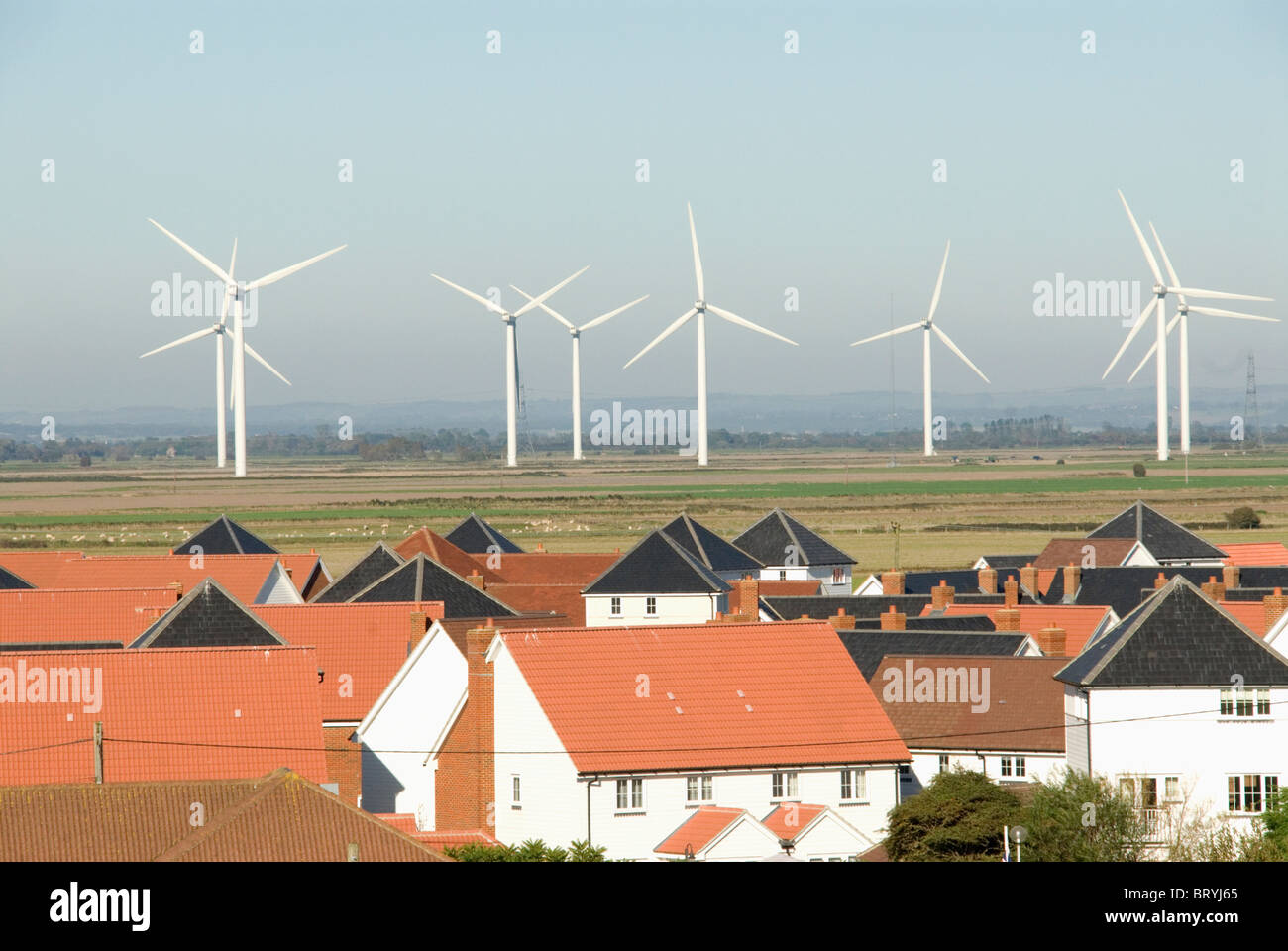 Wind turbines behind housing estate Camber Rye east Sussex Stock Photo ...