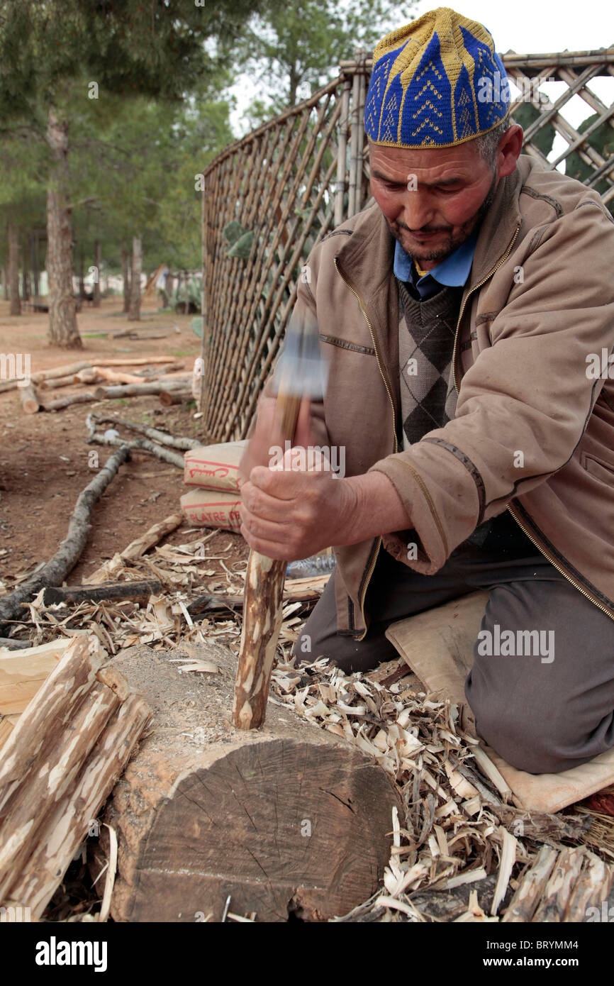 TRADITIONAL BERBER CRAFTSMAN CUTTING WOOD TO MAKE STOOLS, TERRES D ...