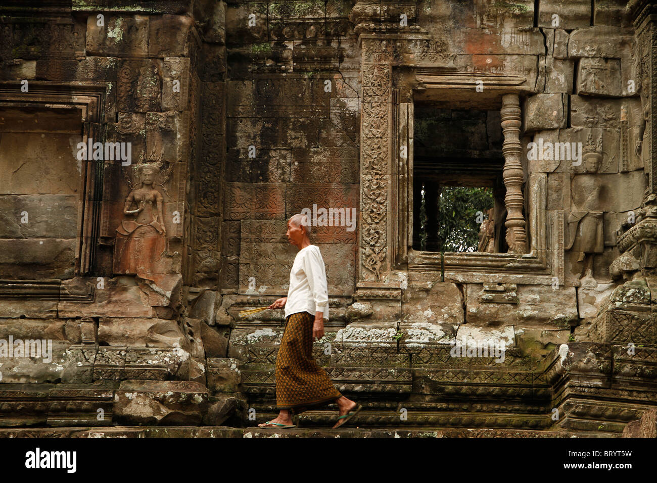 A female Buddhist hermit walks across Chau Say Thevoda Temple in Angkor ...