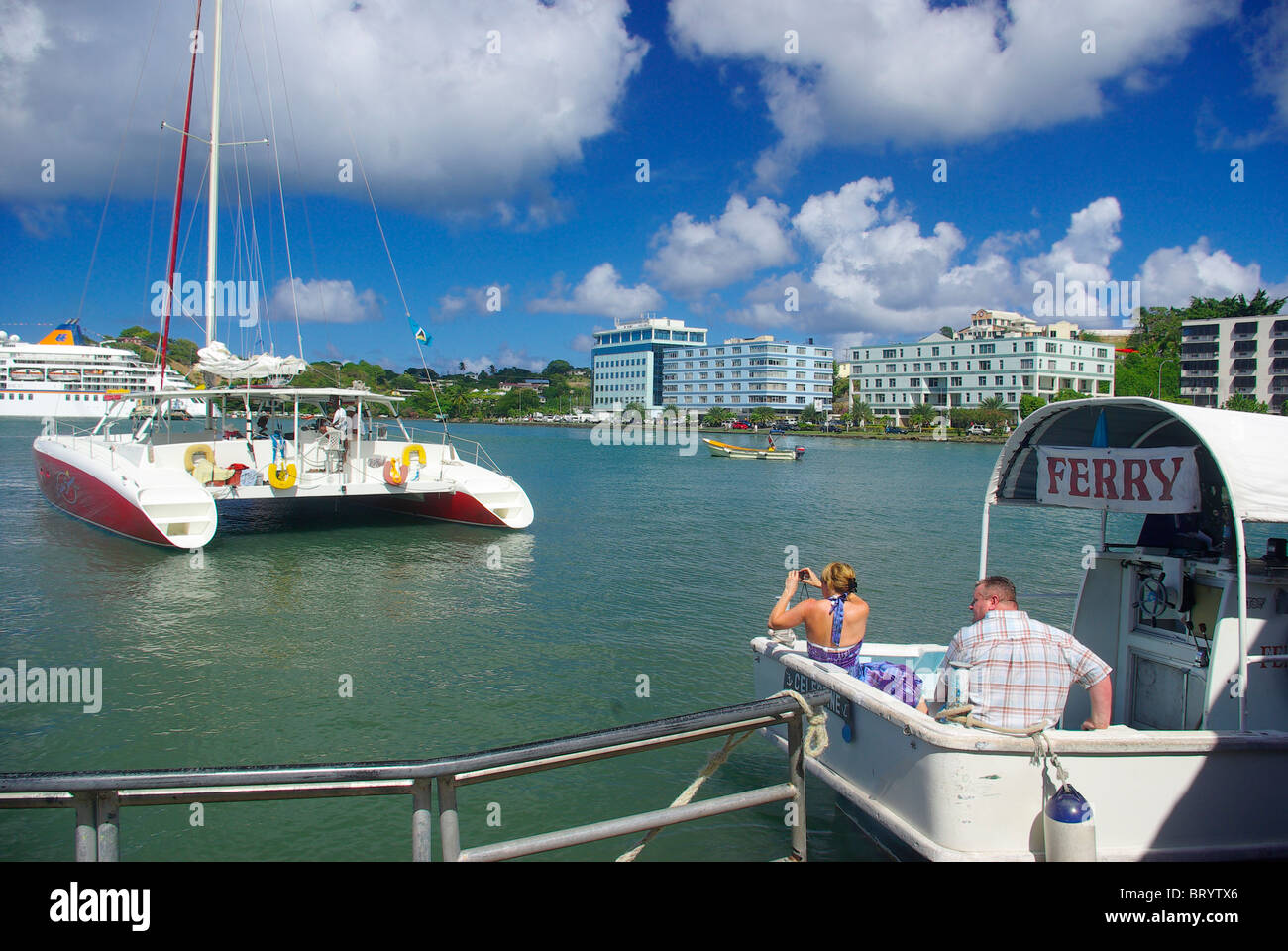 Tourist couple on ferry boat in Castries waterfront harbor Saint Lucia ...