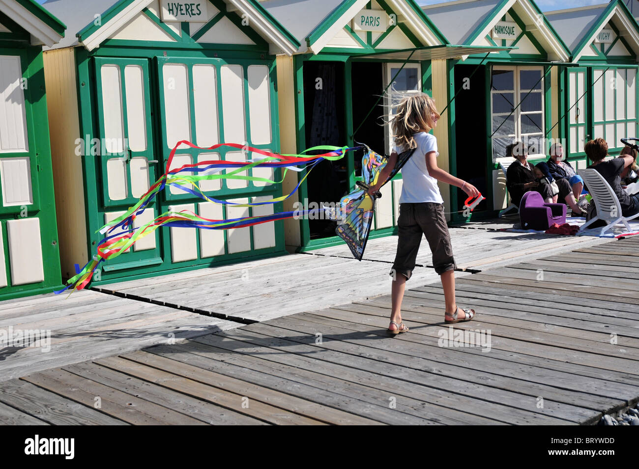 LITTLE GIRL FLYING A KITE, BEACH HUTS, SOMME (80), PICARDY, FRANCE ...