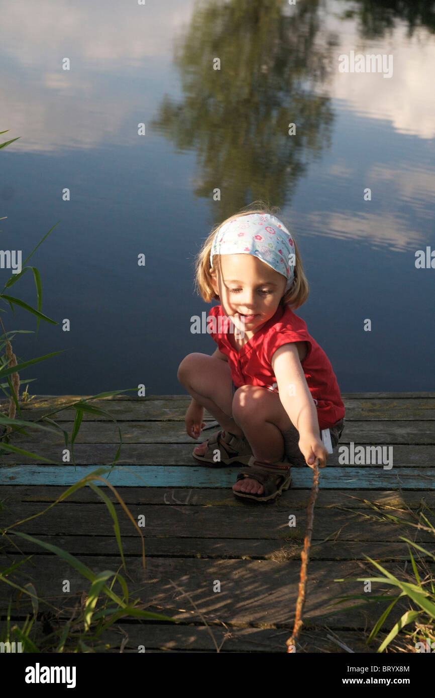 LITTLE GIRL PLAYING ON THE BANKS THE RIVER, SOMME (80), PICARDY, FRANCE ...