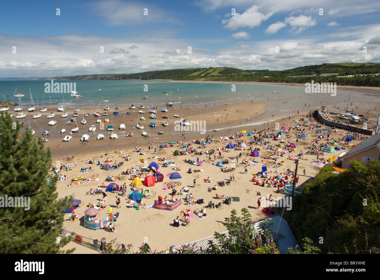 A packed New Quay Beach in Wales during British Summer time Stock Photo ...