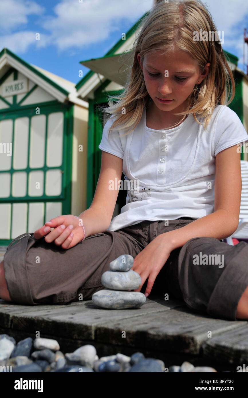 LITTLE GIRL PLAYING WITH PEBBLES, SOMME (80), PICARDY, FRANCE Stock ...