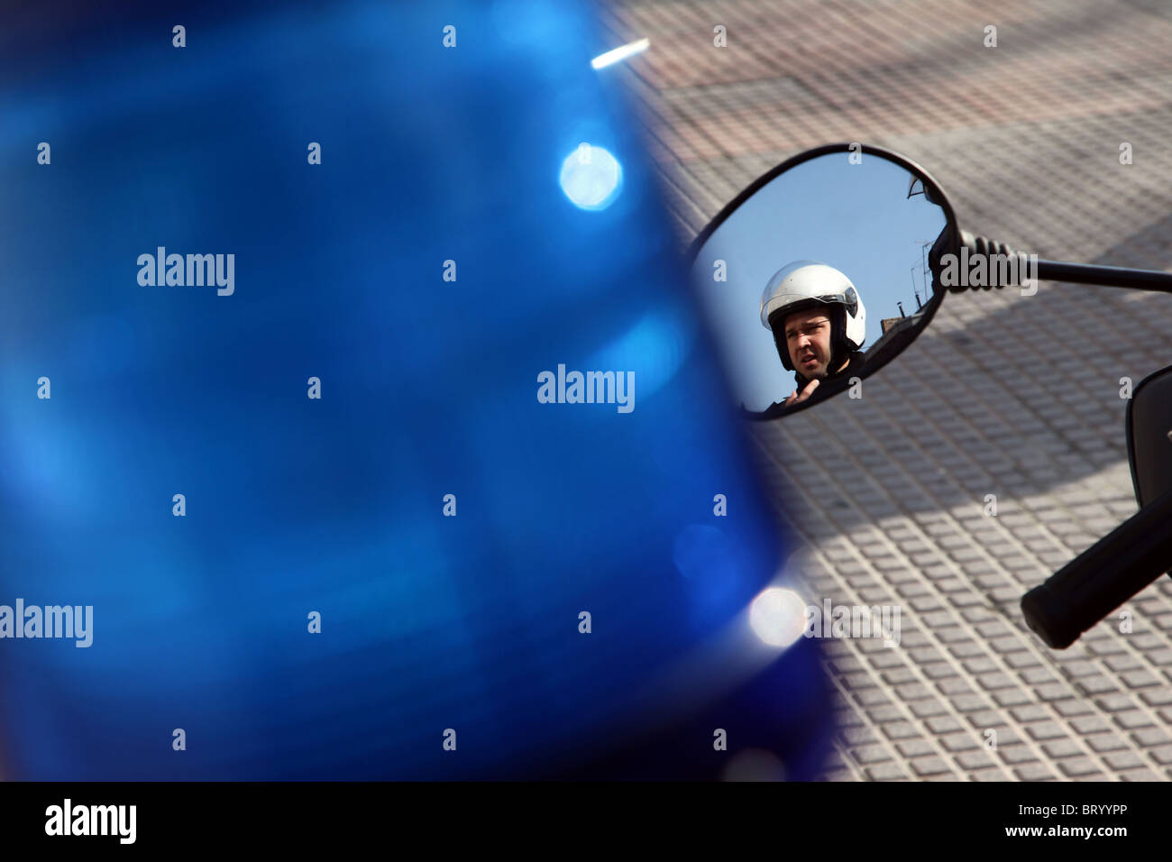 REFLECTION OF A POLICEMAN IN THE REAR VIEW MIRROR OF HIS MOTORCYCLE ...
