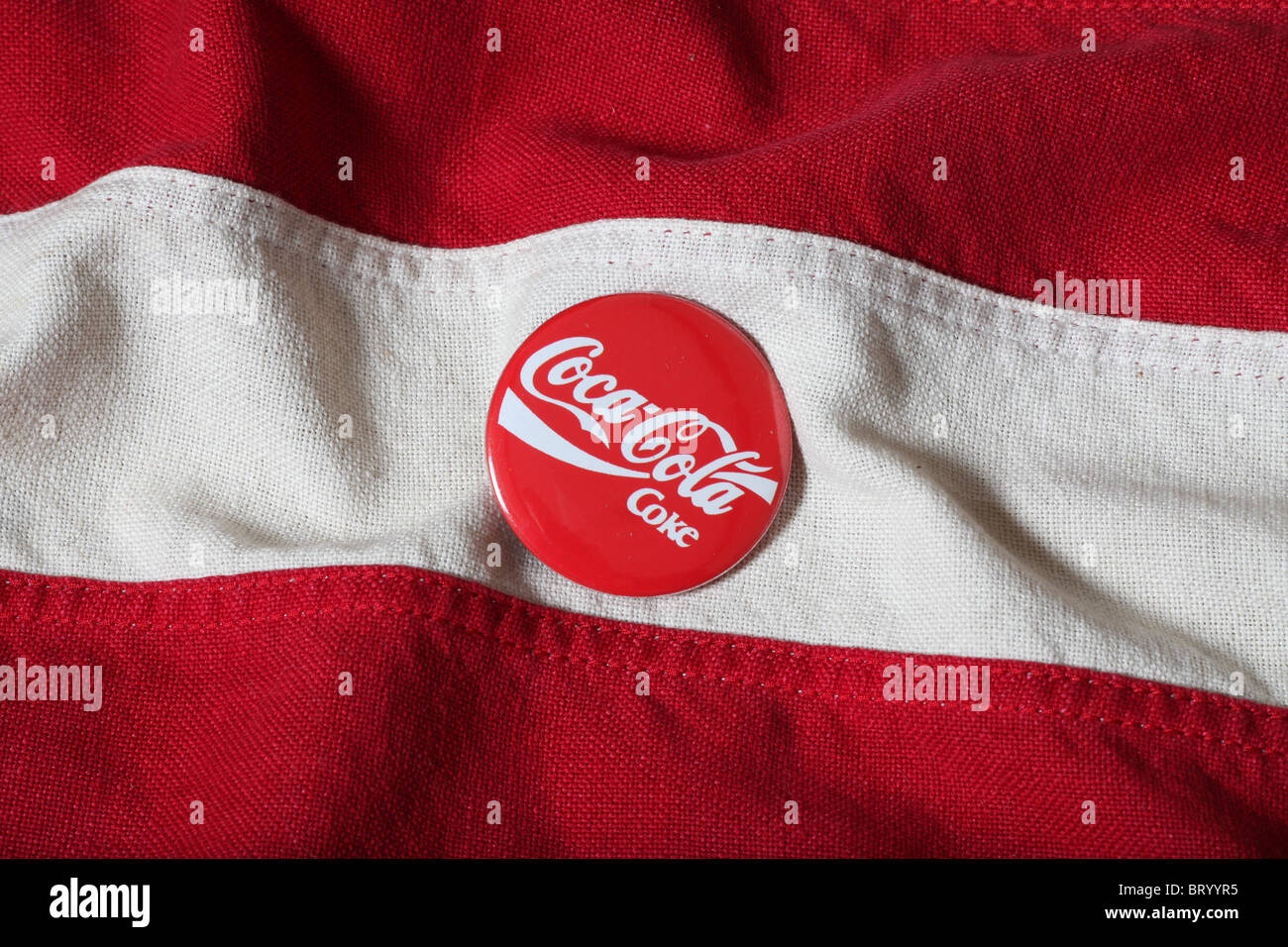A Coca-Cola badge pinned to an American flag Stock Photo - Alamy